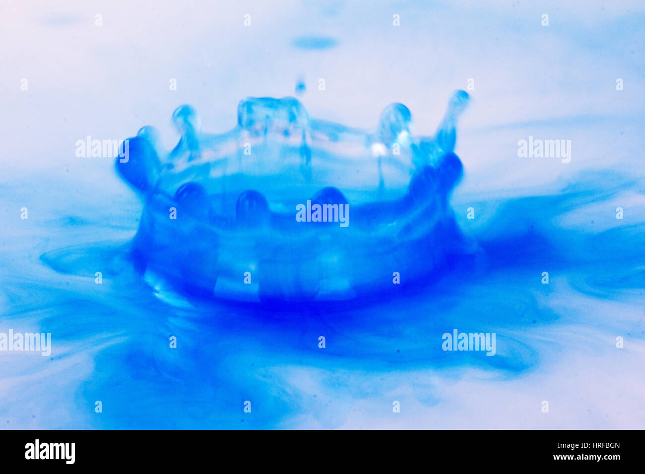 Colorful paint drop splashing on black a background Stock Photo - Alamy