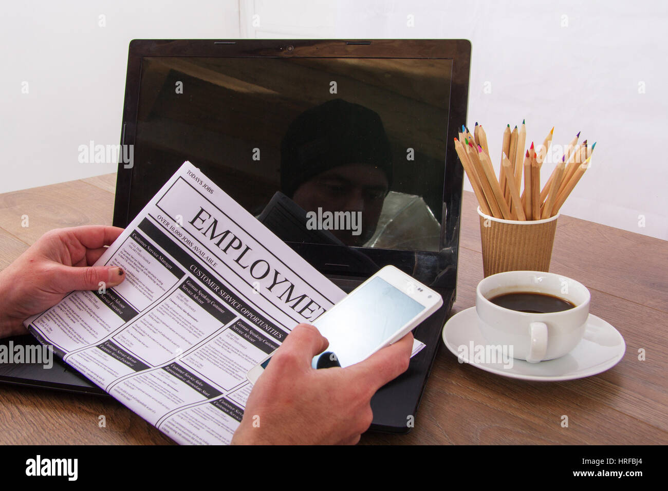 Searching for a new job or employment in a newspaper Stock Photo - Alamy