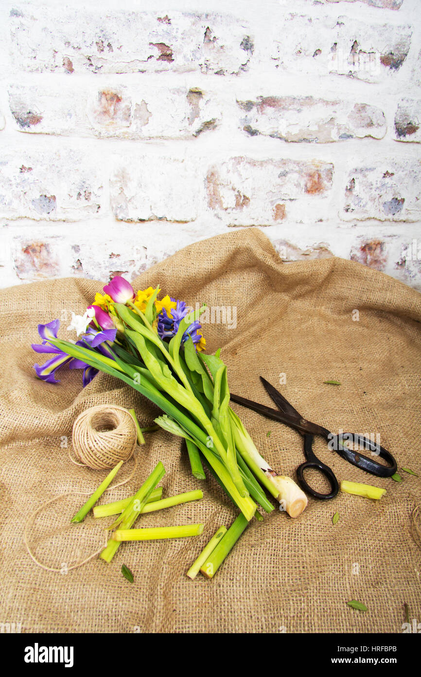 Spring cut flower arrangement against a rustic background Stock Photo ...