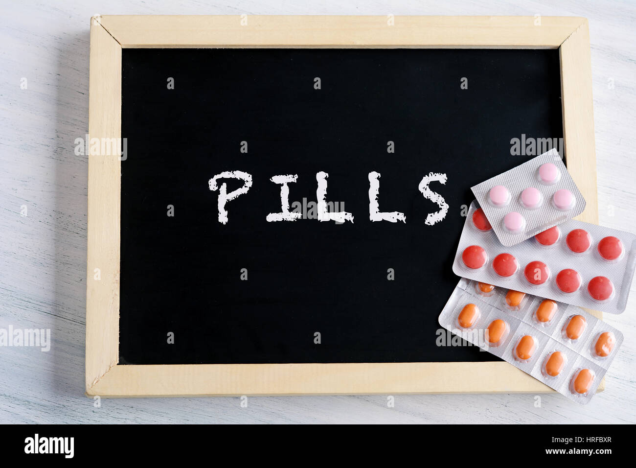 Close-up of empty chalkboard, pills and tablets. Healthcare concept ...