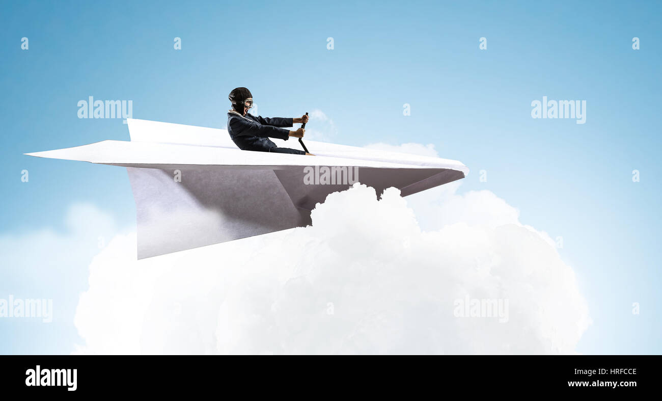 Young cheerful pilot woman flying in paper plane Stock Photo - Alamy