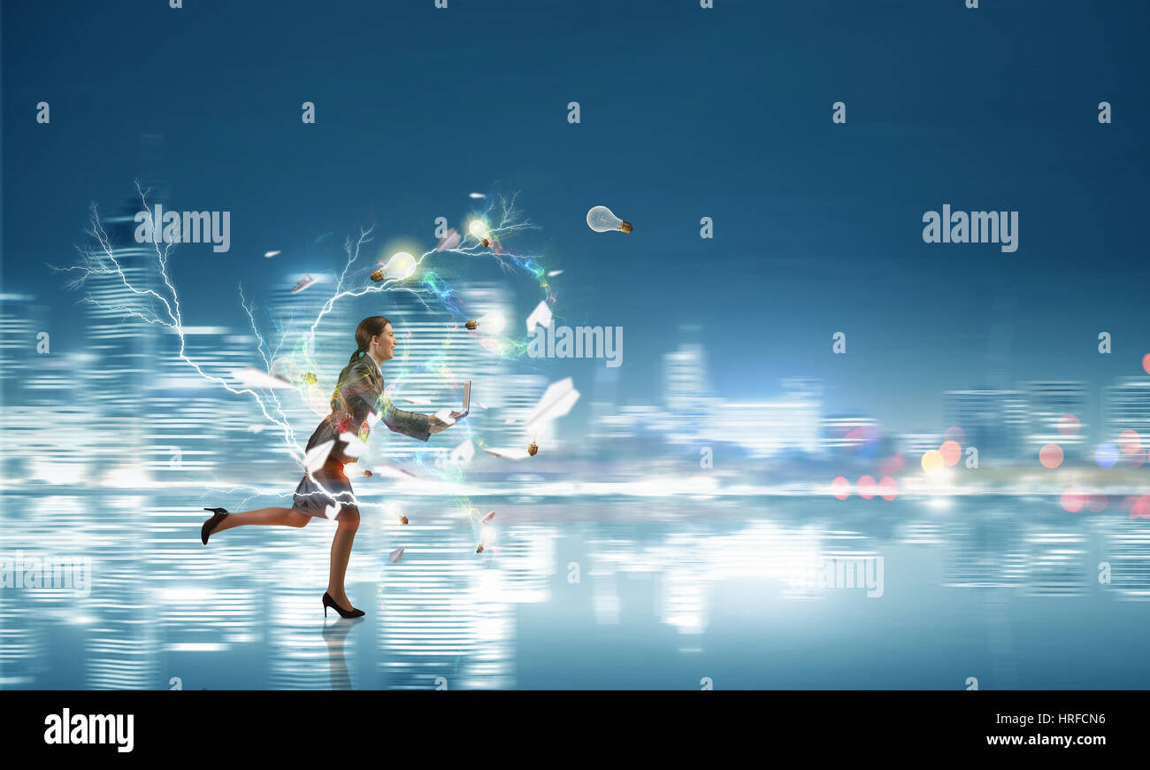 Successful businesswoman running with laptop computer in hands Stock ...