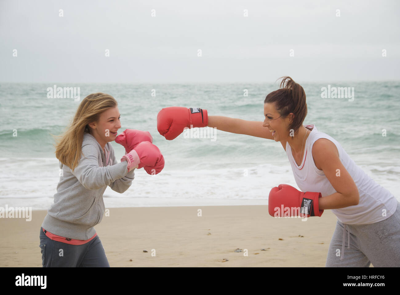 Two sisters boxing on the beach Stock Photo - Alamy