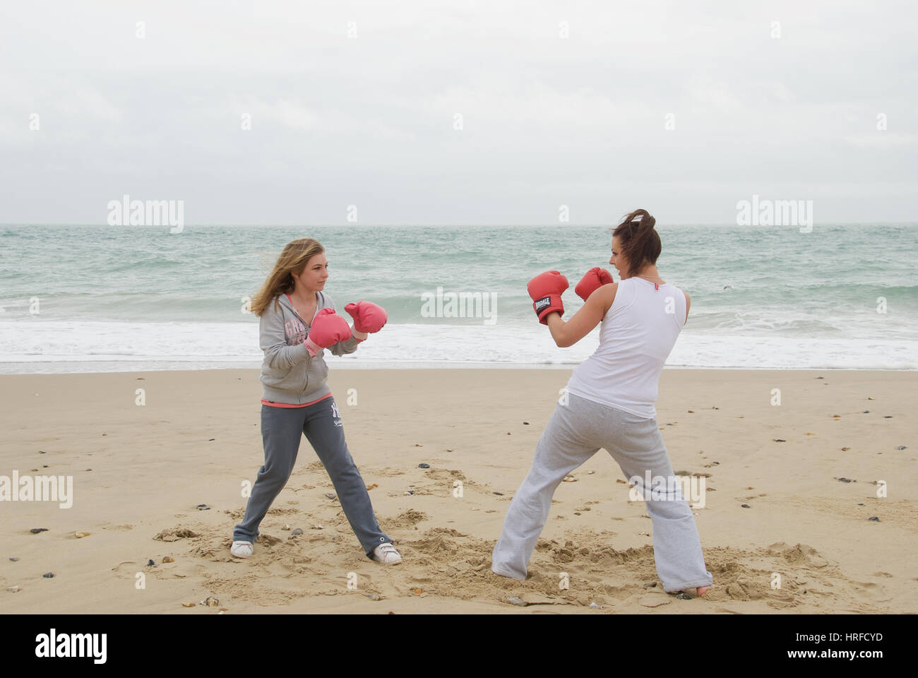 Two sisters boxing on the beach Stock Photo - Alamy
