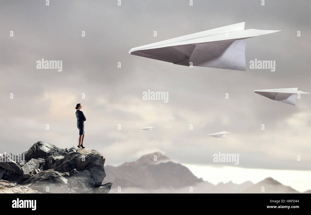 Elegant businesswoman and big paper plane flying in sky. Mixed media ...