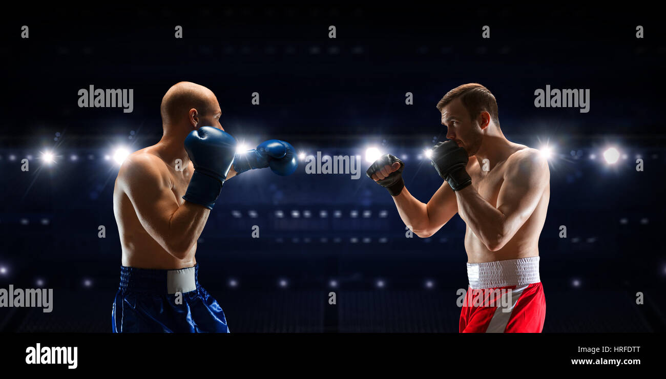Two professional boxers fighting at sport arena. Mixed media Stock ...