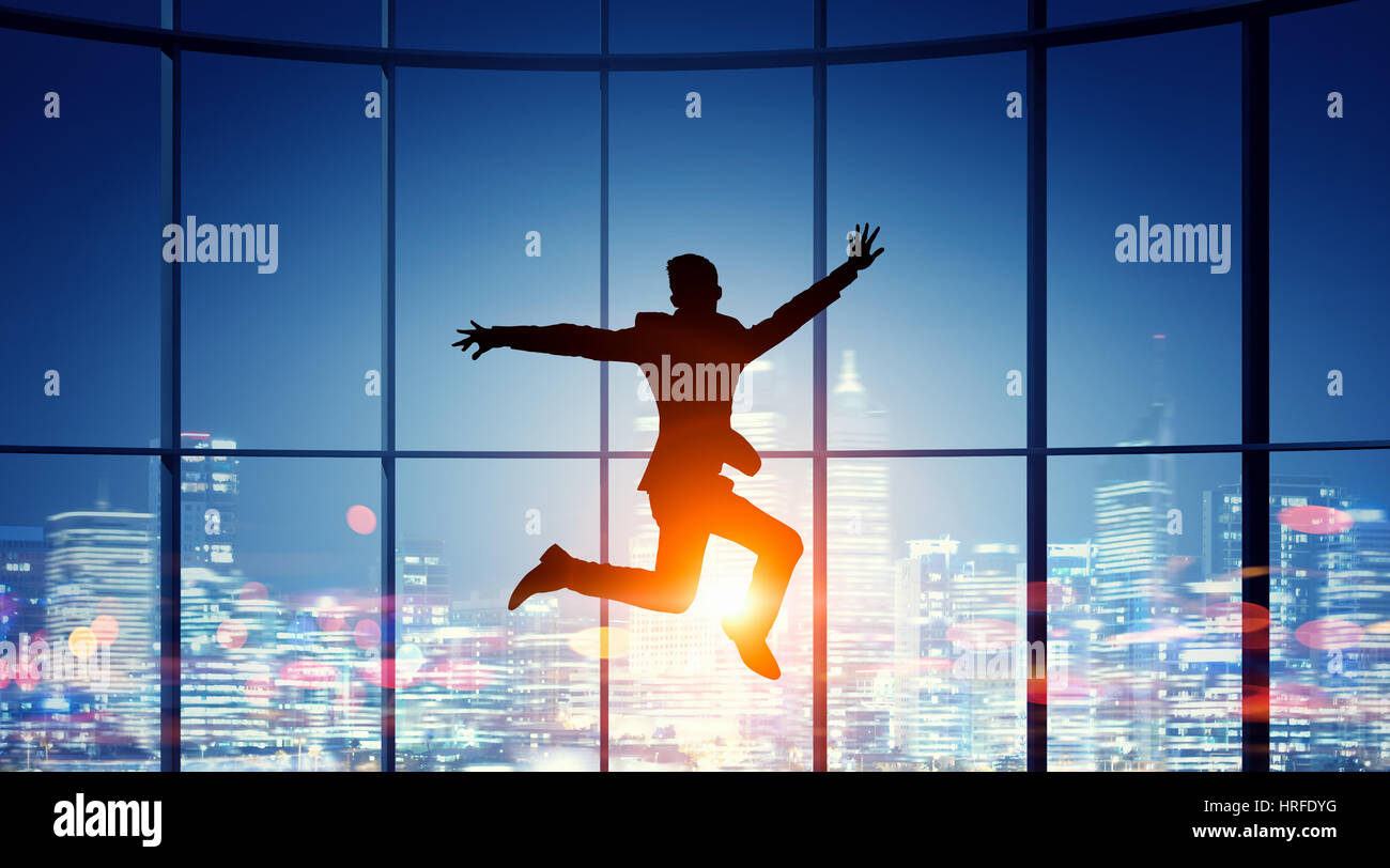 Silhouette businessman jumping over night hi-res stock photography and ...