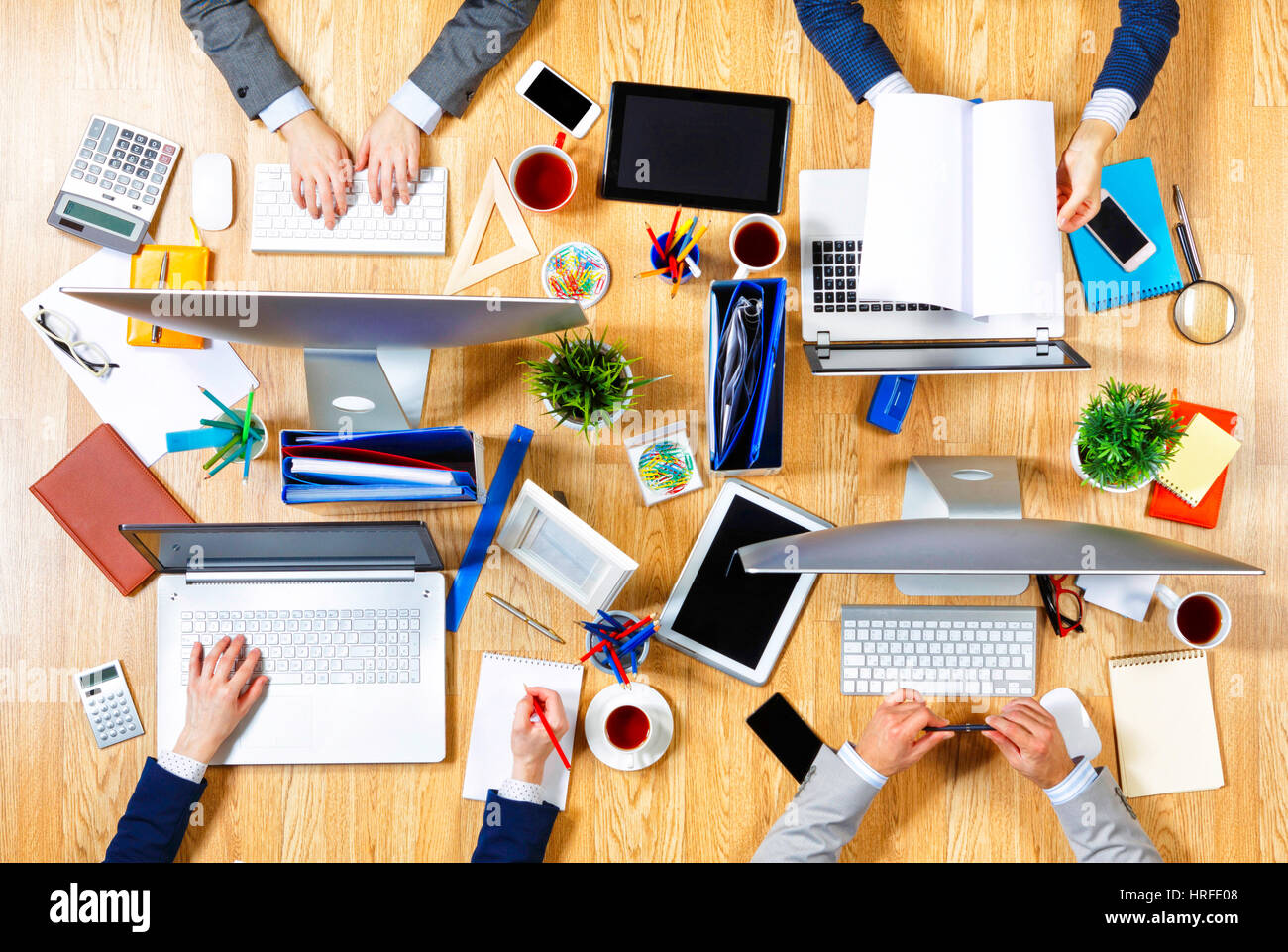 Top view of office table with four colleagues working together Stock ...