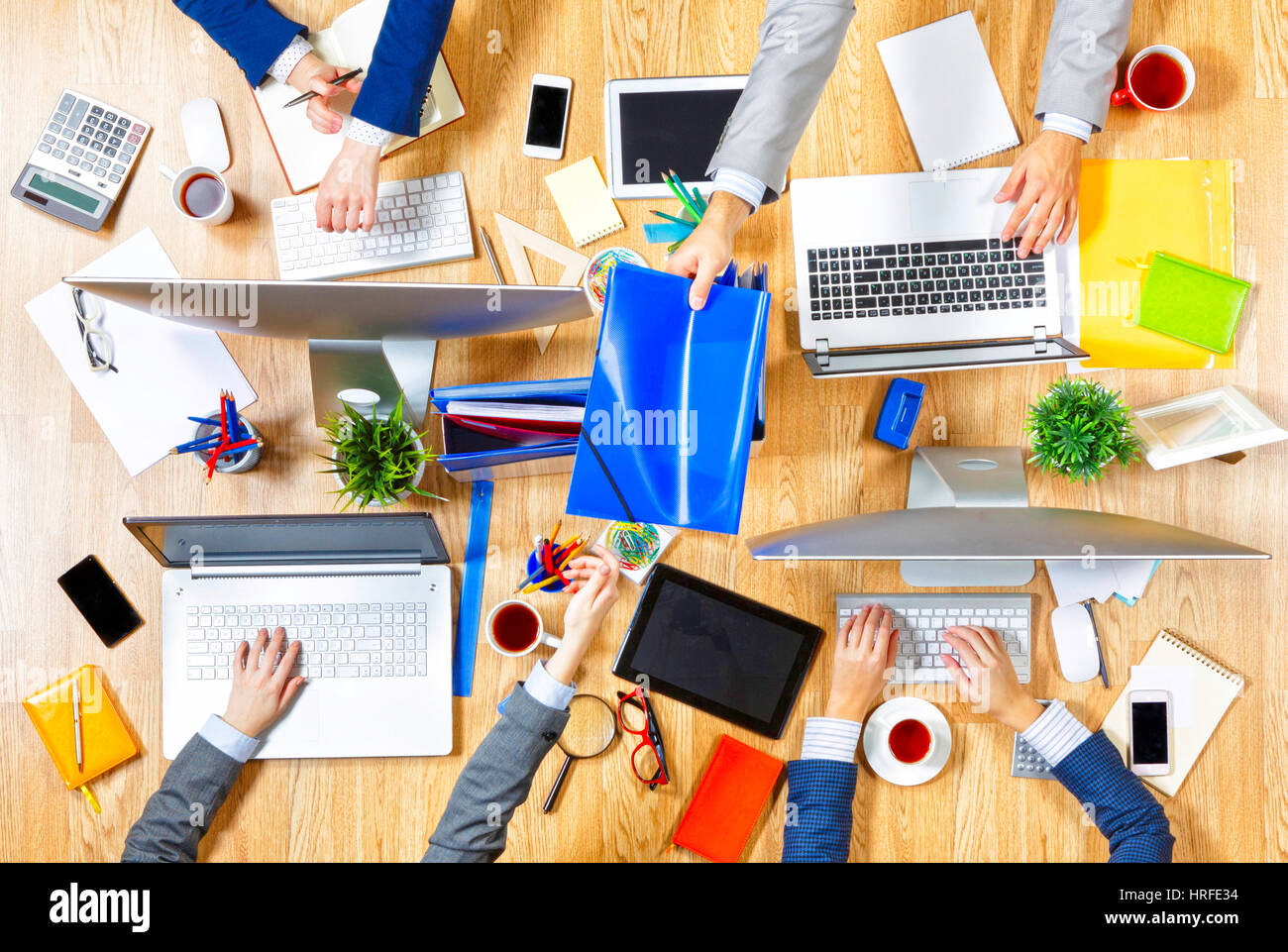 Top view of office table with four colleagues working together Stock ...