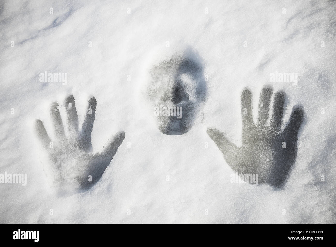 Face and hand print in snow Stock Photo - Alamy