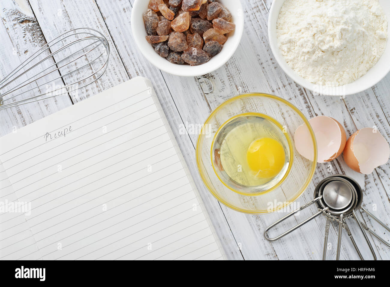 Note book and ingredients for baking on a wooden background Stock Photo ...