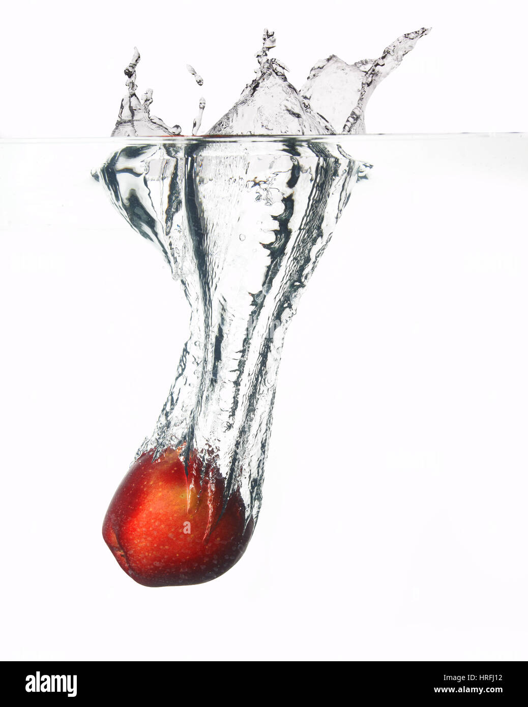 Apple falls deeply under water with a big splash Stock Photo - Alamy