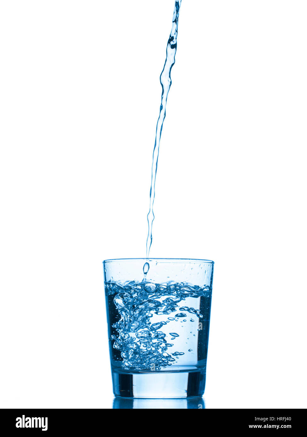 Water poured into glass. Isolated on white background Stock Photo - Alamy