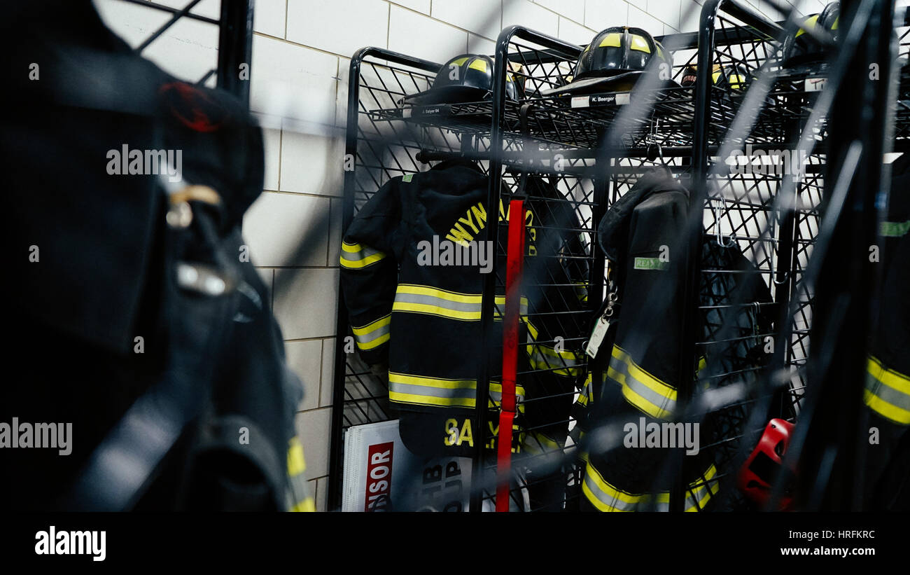 The helmet and jacket of inside a firehouse Stock Photo - Alamy