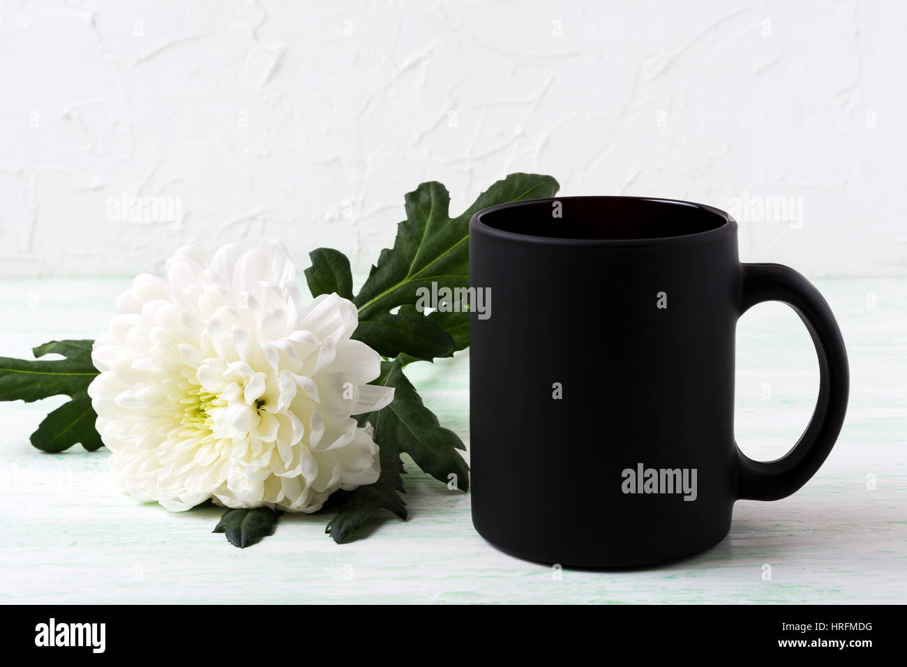 Black coffee mug mockup with white chrysanthemum. Empty mug mock up for ...