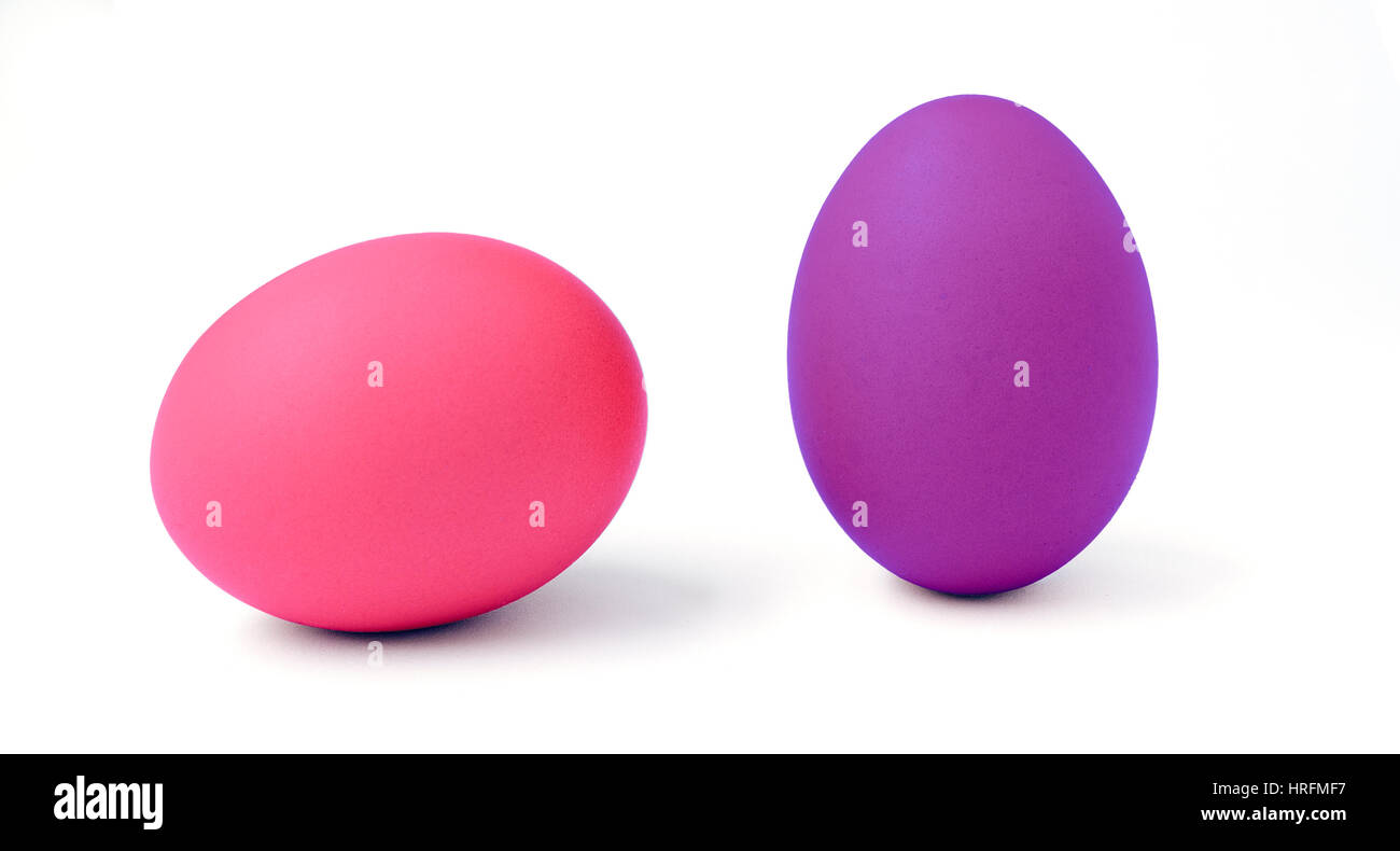 A bright pink Easter egg and a purple dyed egg isolated on white Stock ...