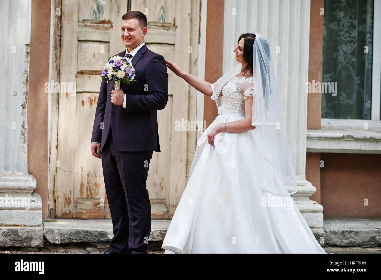 Solid wedding couple background old building with columns Stock Photo ...
