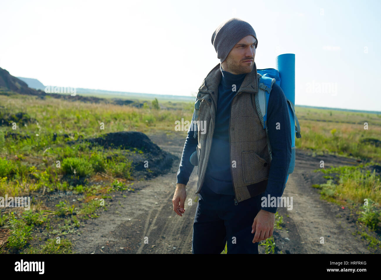 Model shot in bright sunlight of adventurous handsome hiker wearing ...
