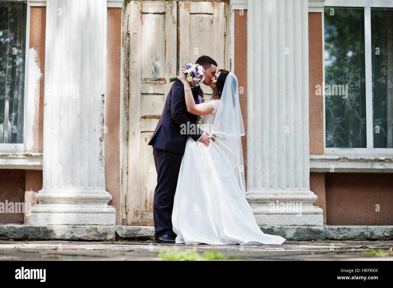 Solid wedding couple background old building with columns Stock Photo ...