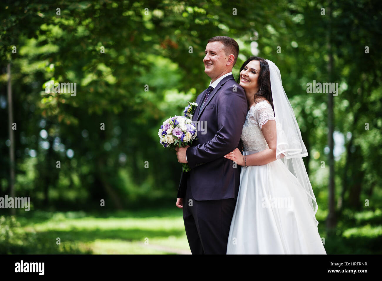 Magnificent wedding couple background green park in love Stock Photo ...