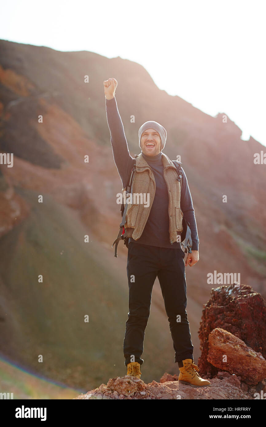 Model shot in bright sunlight of adventurous traveler wearing ...