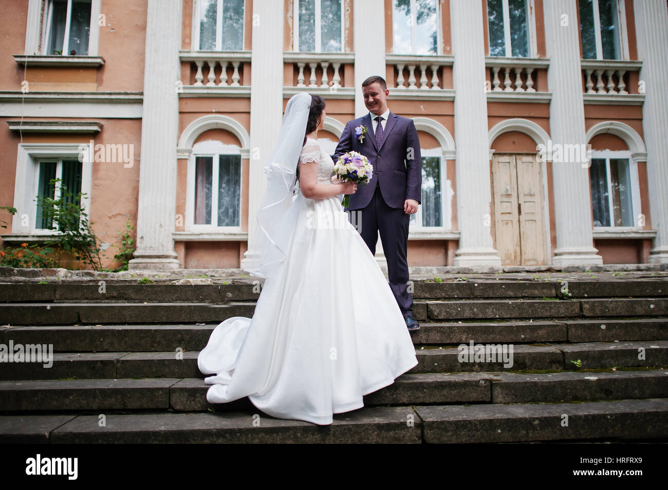 Solid wedding couple background old building with columns Stock Photo ...
