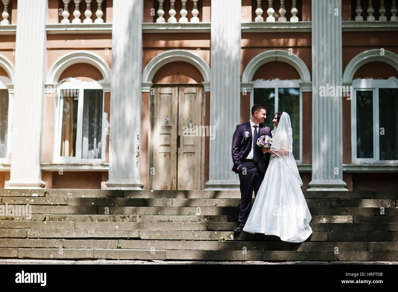 Solid wedding couple background old building with columns Stock Photo ...