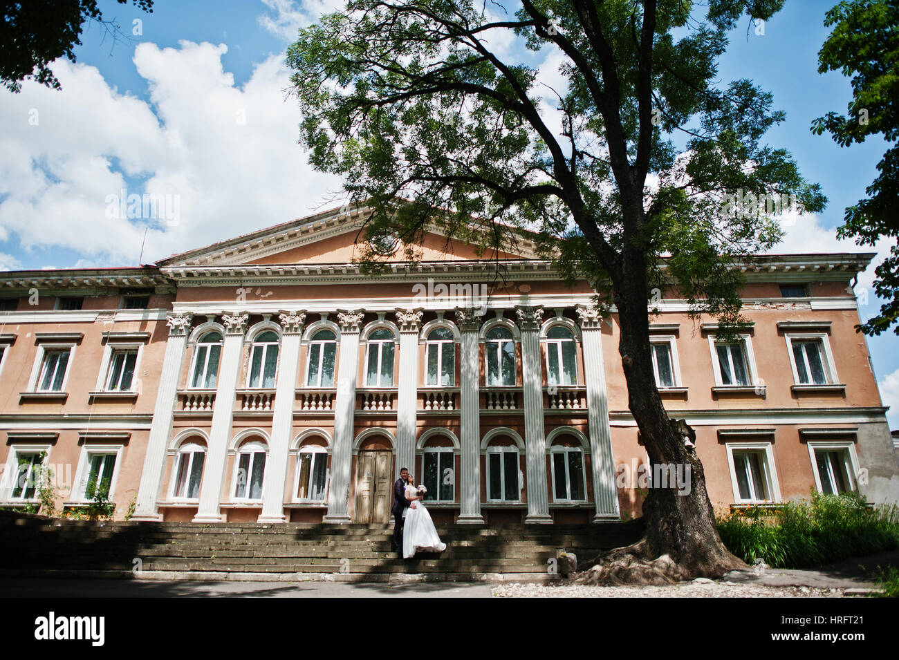 Solid wedding couple background old building with columns Stock Photo ...