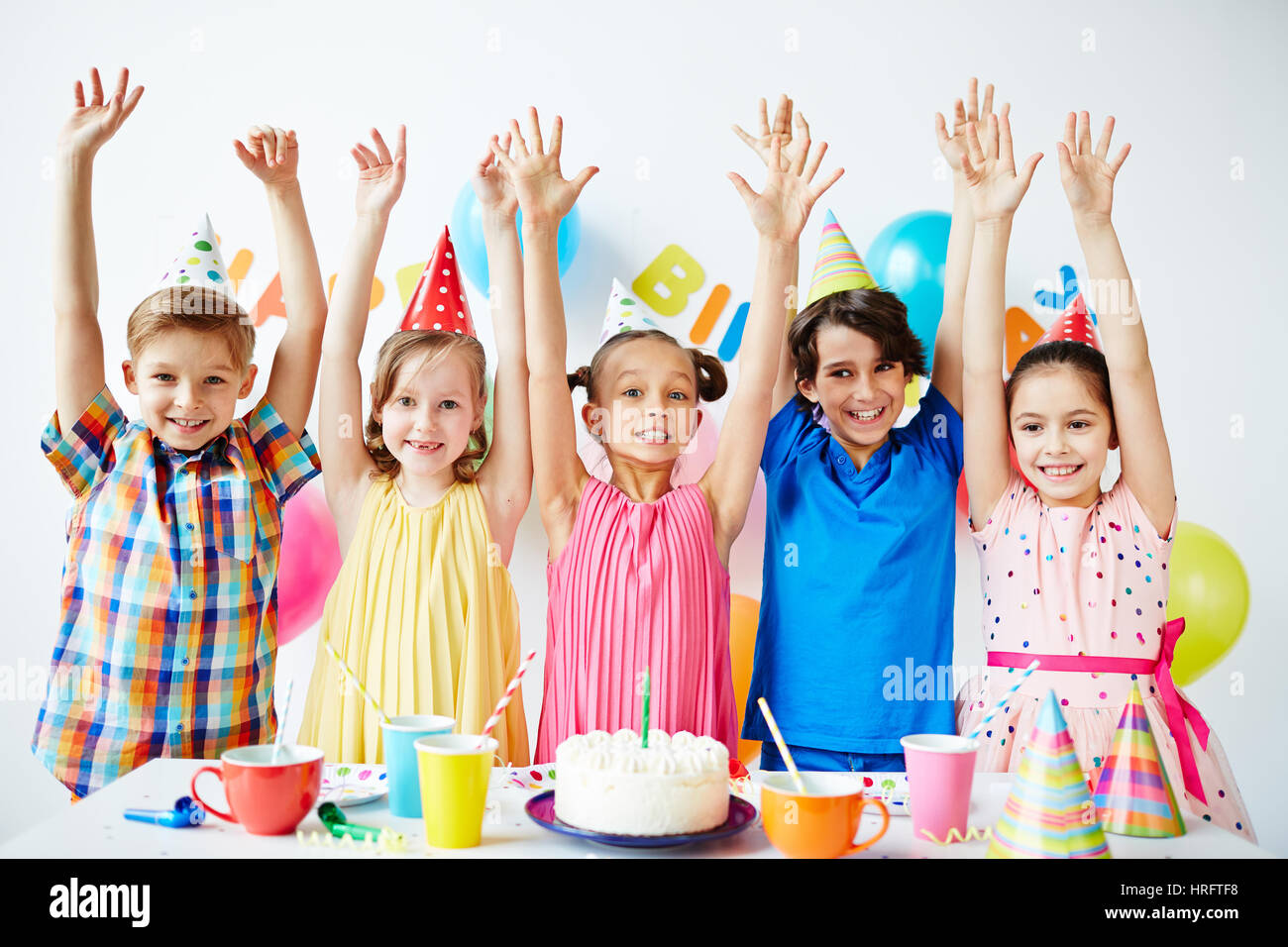 Group of five cheerful children smiling brightly standing in a row ...