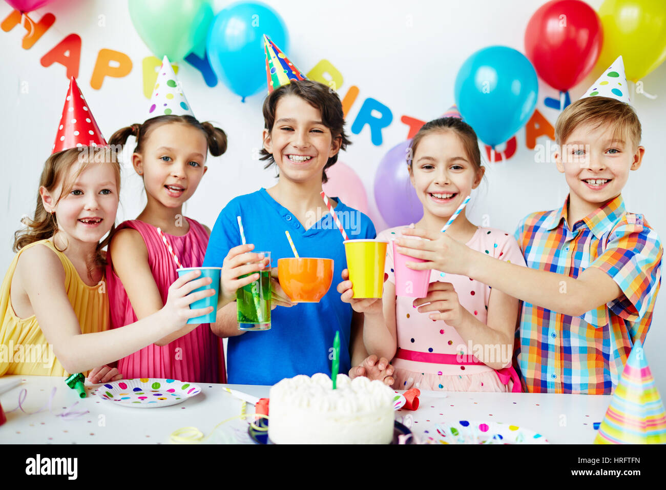 Colorful portrait of five happy kids standing together posing, holding ...