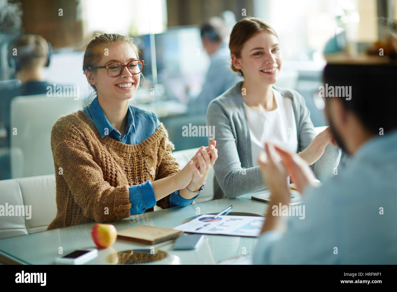 Group of cheerful managers applauding to lecturer during business ...