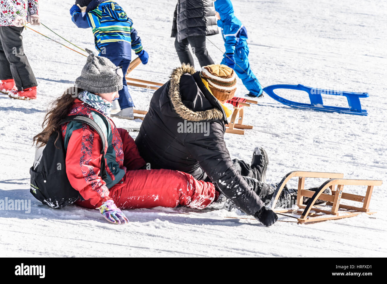 Girls fell off the sled Stock Photo - Alamy