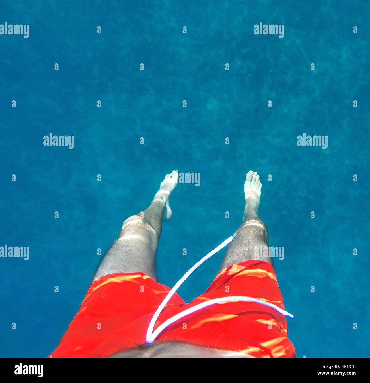 Man floating in sea water Stock Photo - Alamy