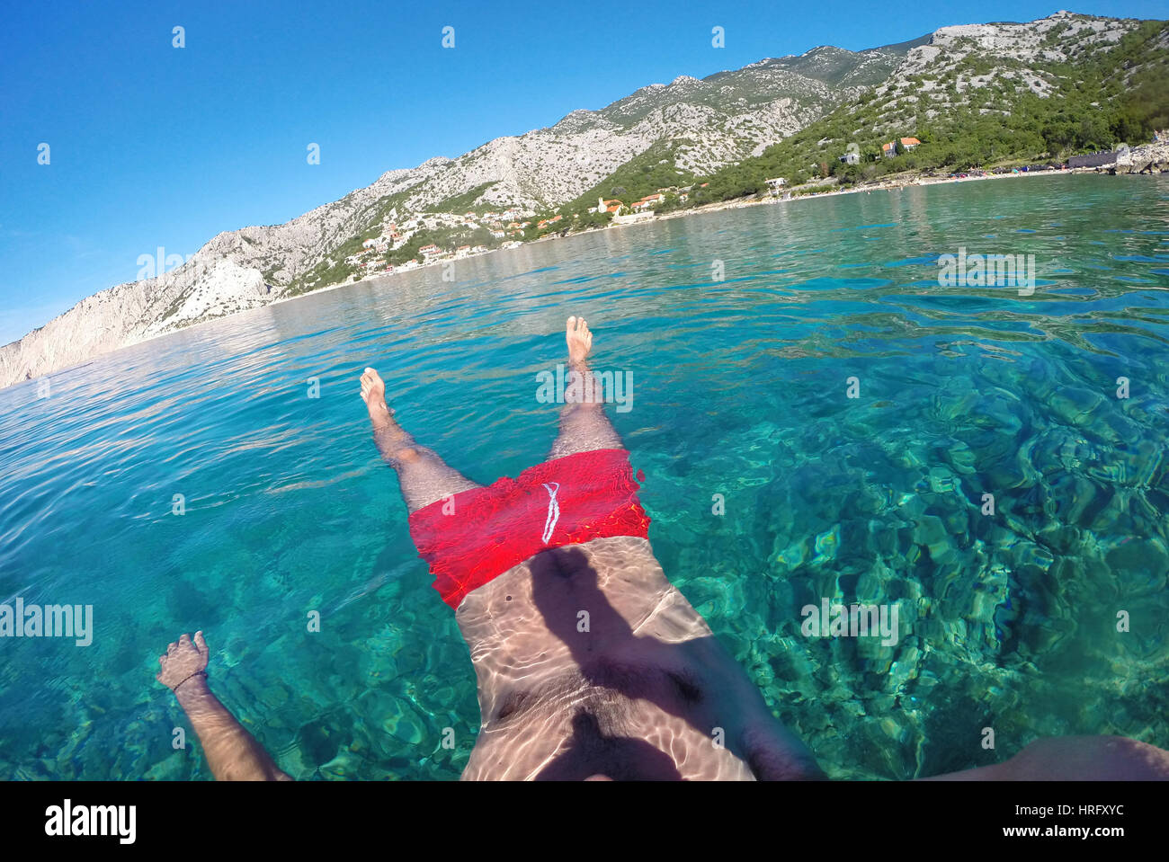 Man floating in sea water Stock Photo - Alamy