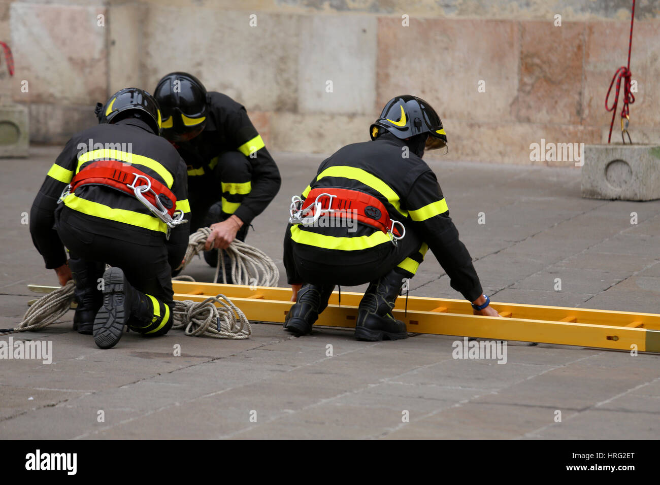 many firefighters with ladder to reach the upper floors of the building ...