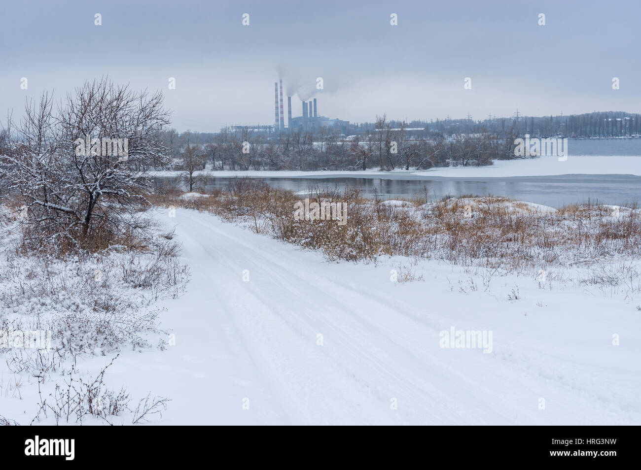 Winter landscape with snow covered earth road near Dnepr city, Ukraine ...
