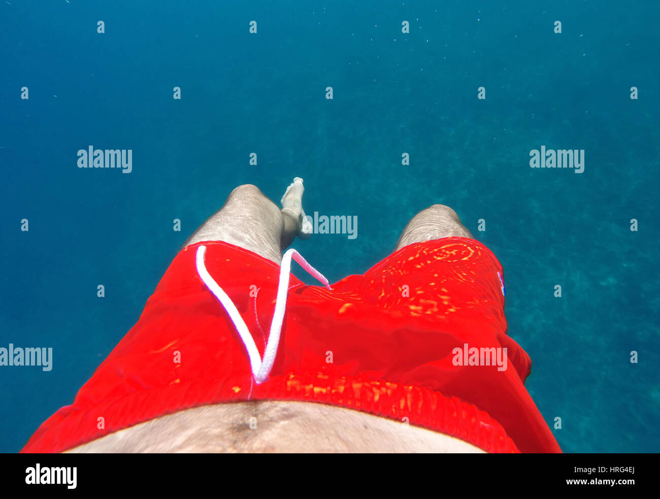Man floating in sea water Stock Photo - Alamy