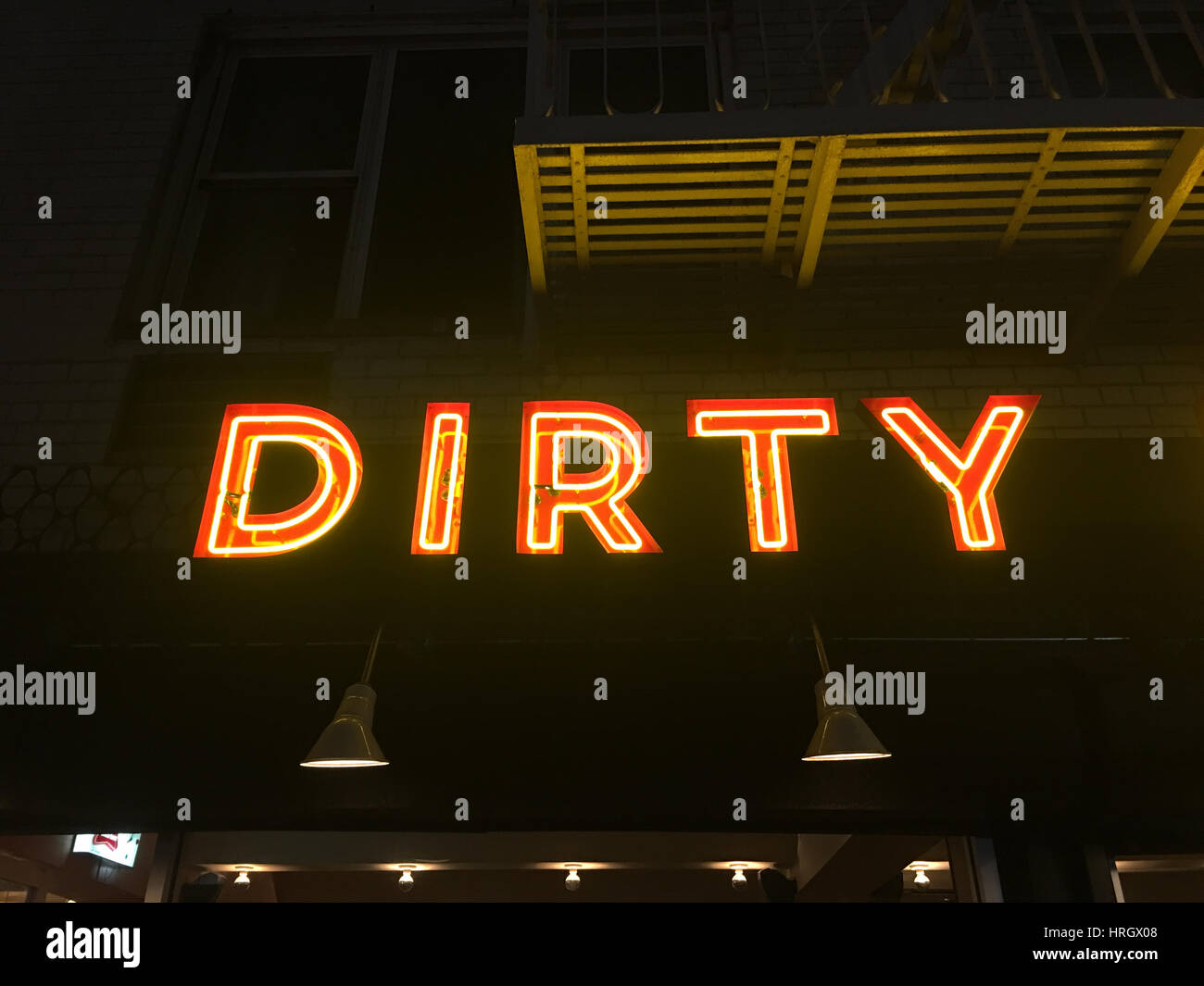 Neon sign at night with the world dirty in red capital letters Stock ...