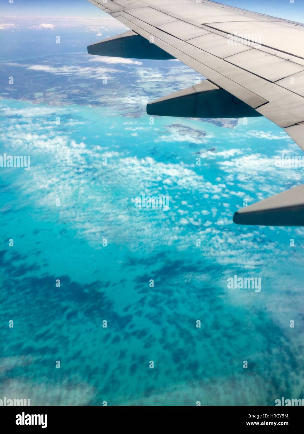 View of airplane wing from inside on a flight to the Caribbean Stock ...