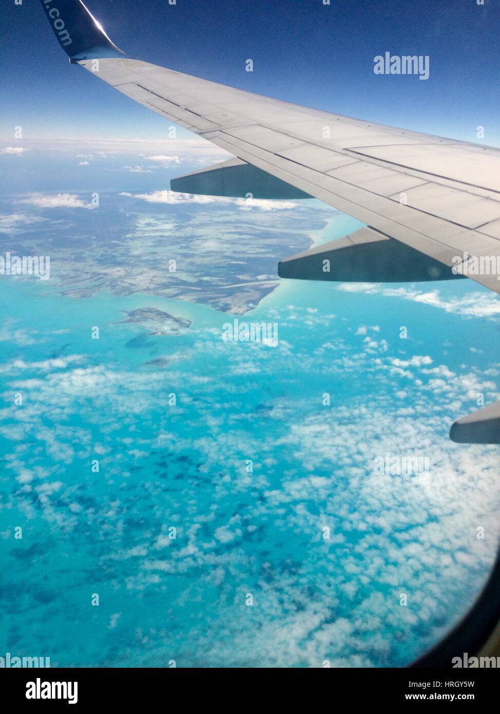 View of airplane wing from inside on a flight to the Caribbean Stock ...
