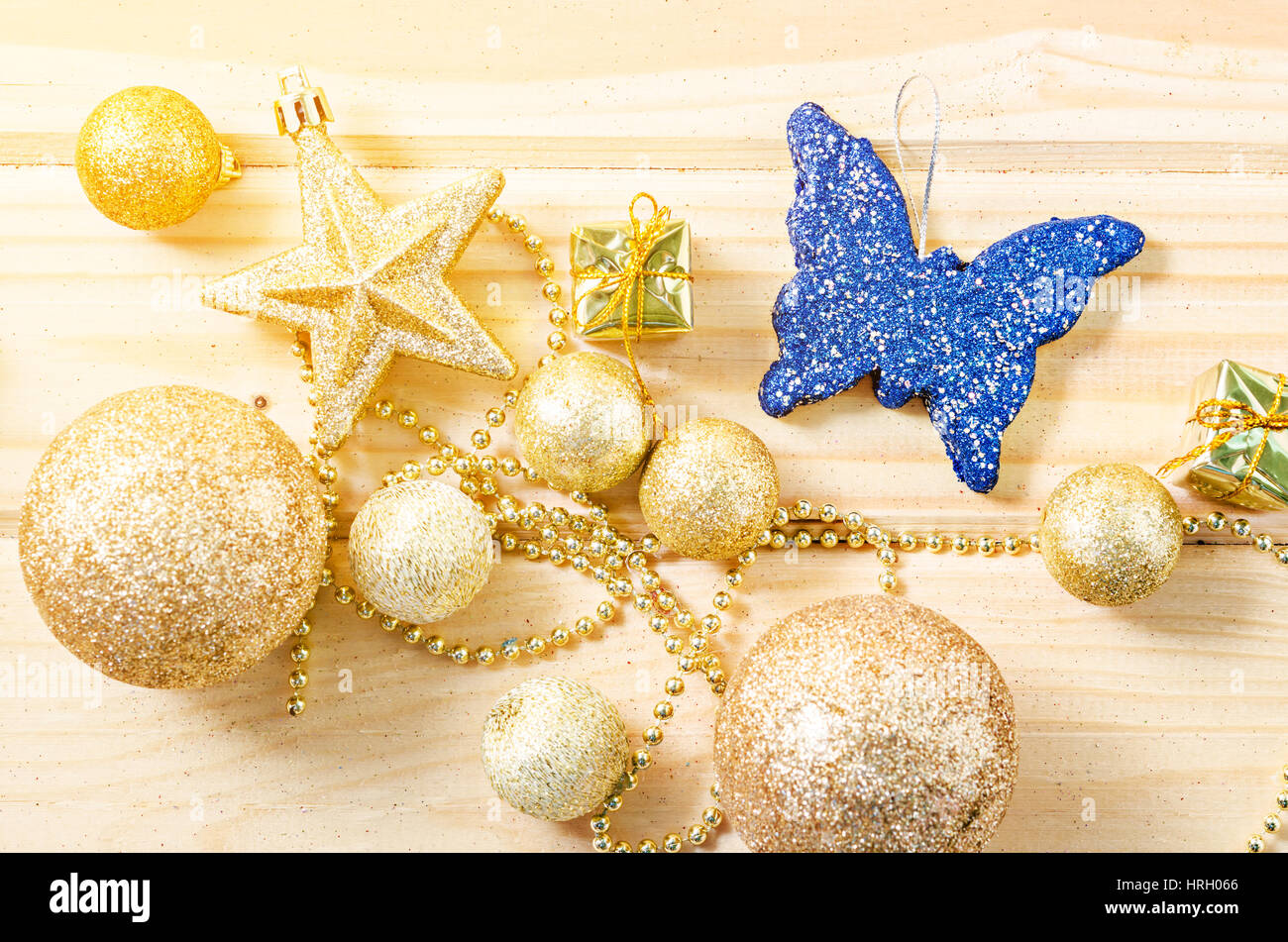 Gold theme color christmas decorations on wooden background with ...