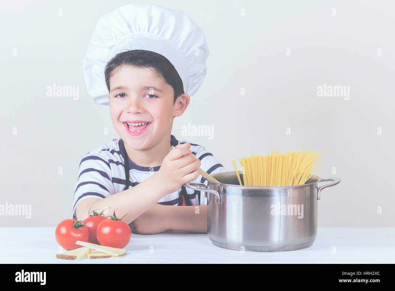 Funny happy boy chef cooking at restaurant kitchen Stock Photo - Alamy