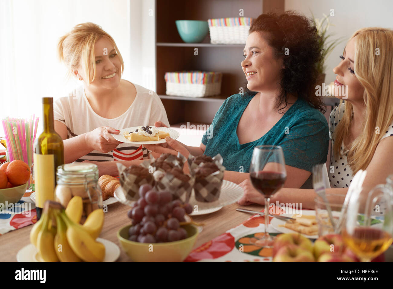 Woman passing plate food table hi-res stock photography and images - Alamy
