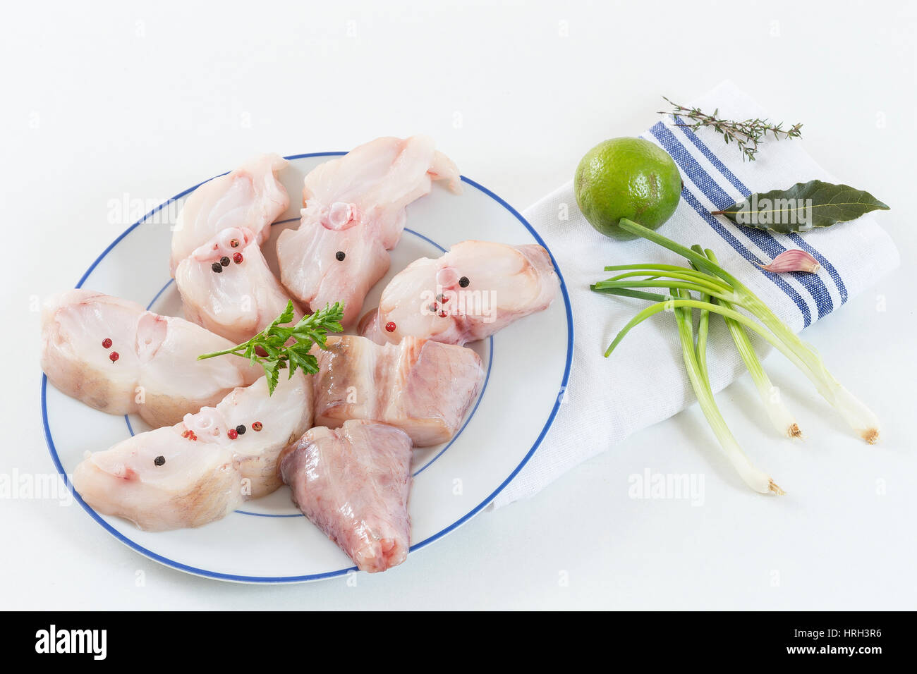 some monkfish slices on a white background Stock Photo - Alamy