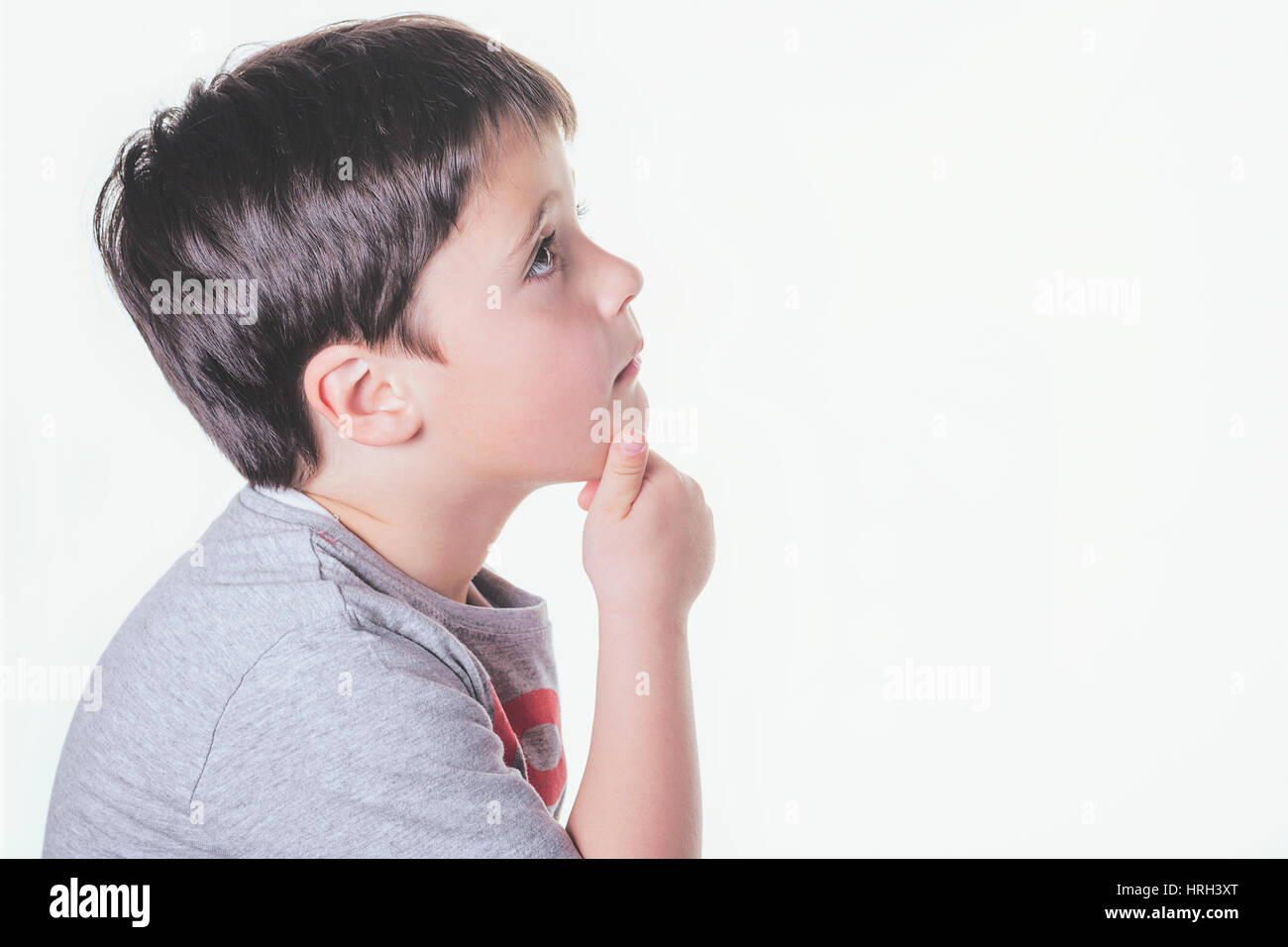 Pensive child on white background Stock Photo - Alamy