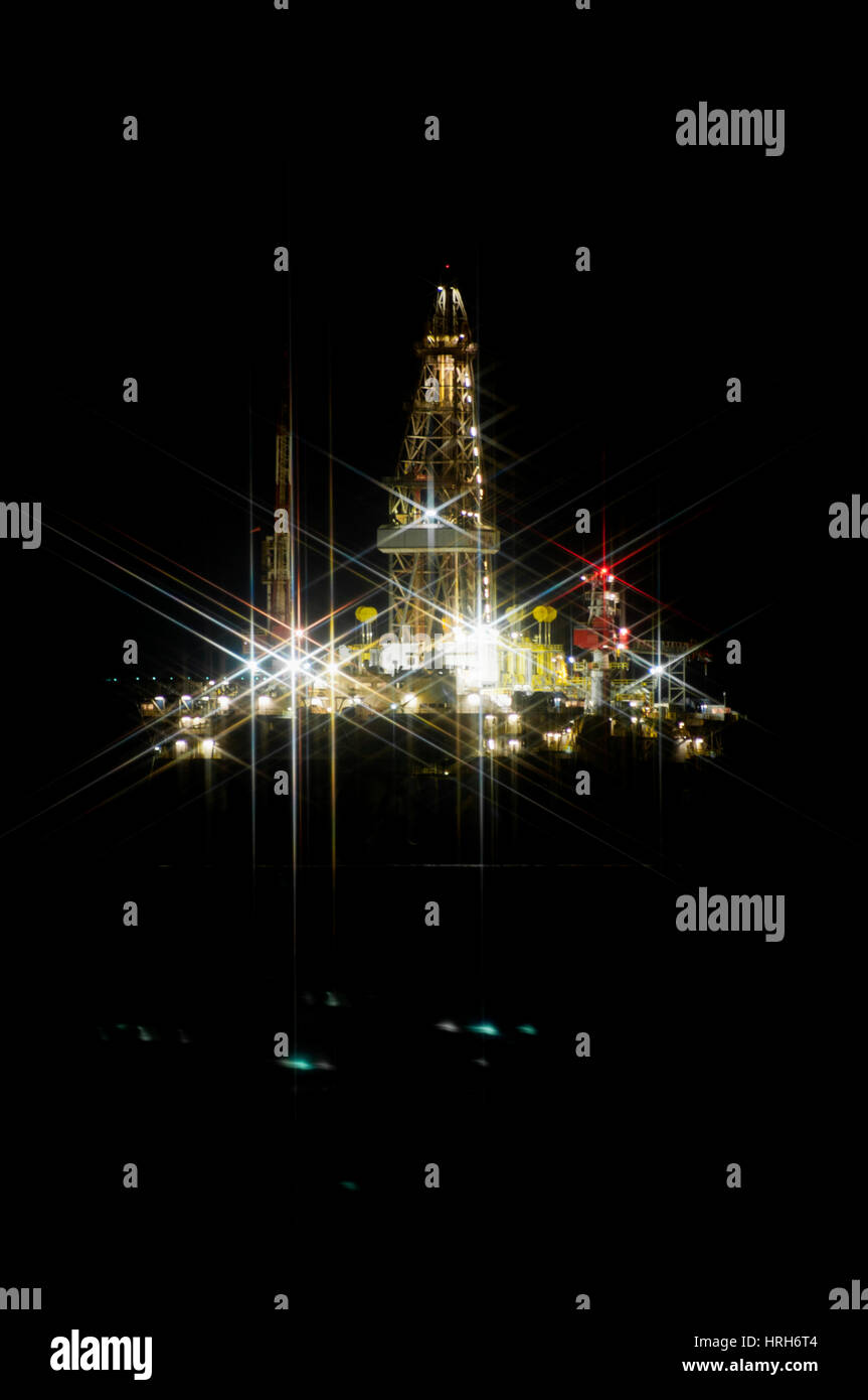 Offshore drilling rig at night Stock Photo - Alamy