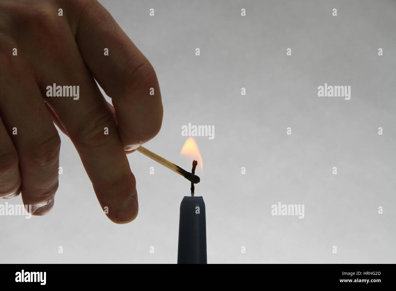 Lighting a candle Stock Photo - Alamy