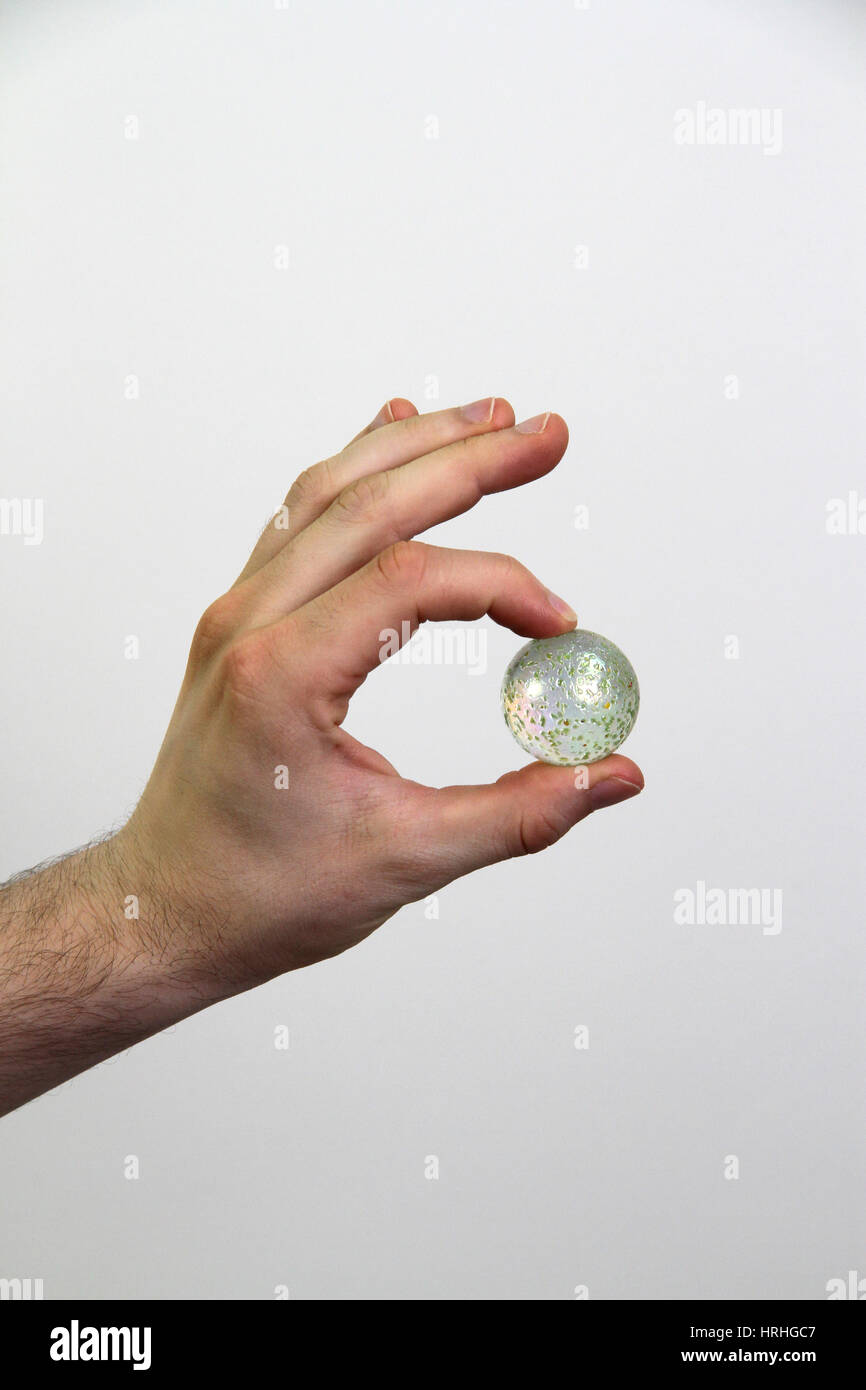 Hand holding marble Stock Photo - Alamy