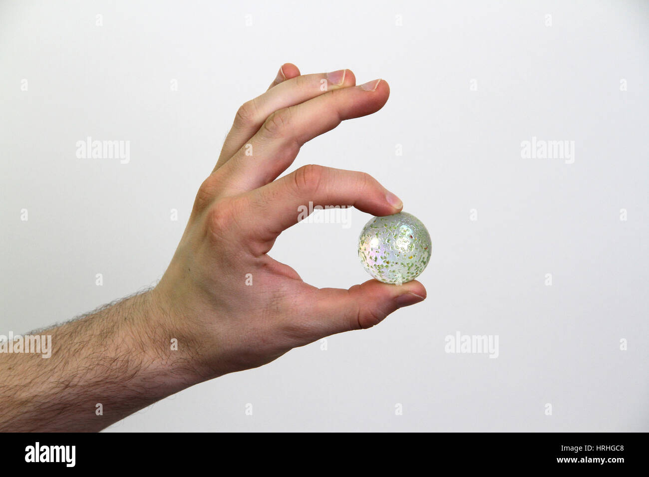 Hand holding marble Stock Photo - Alamy