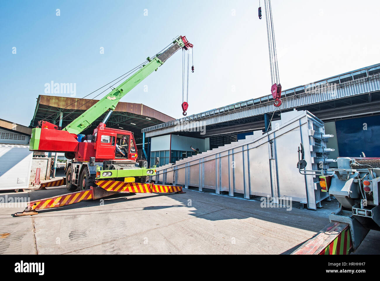 Mobile crane operating by lifting and moving an heavy electric ...
